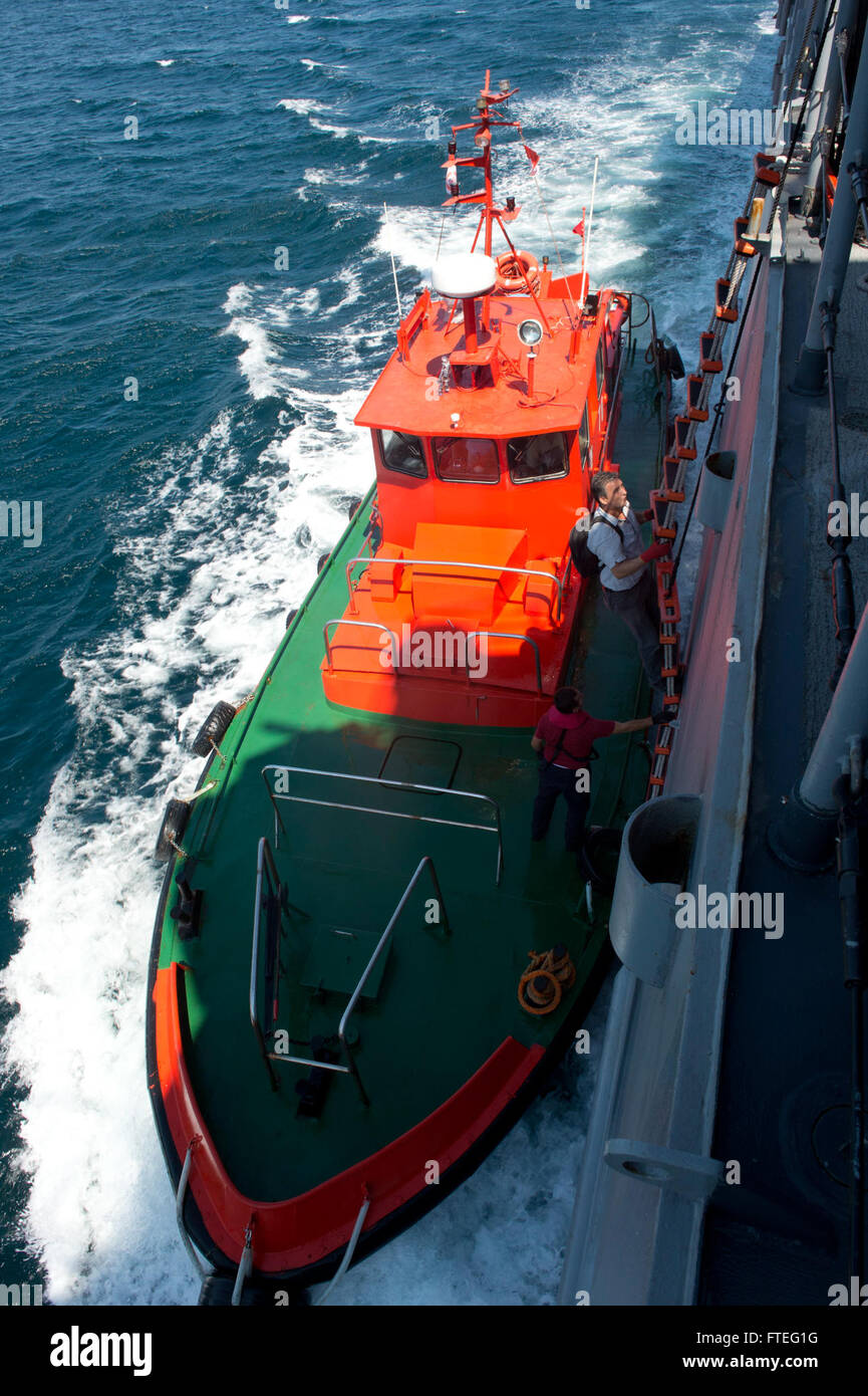 A U.S. Navy pilot boards the Ticonderoga-class guided-missile cruiser ...