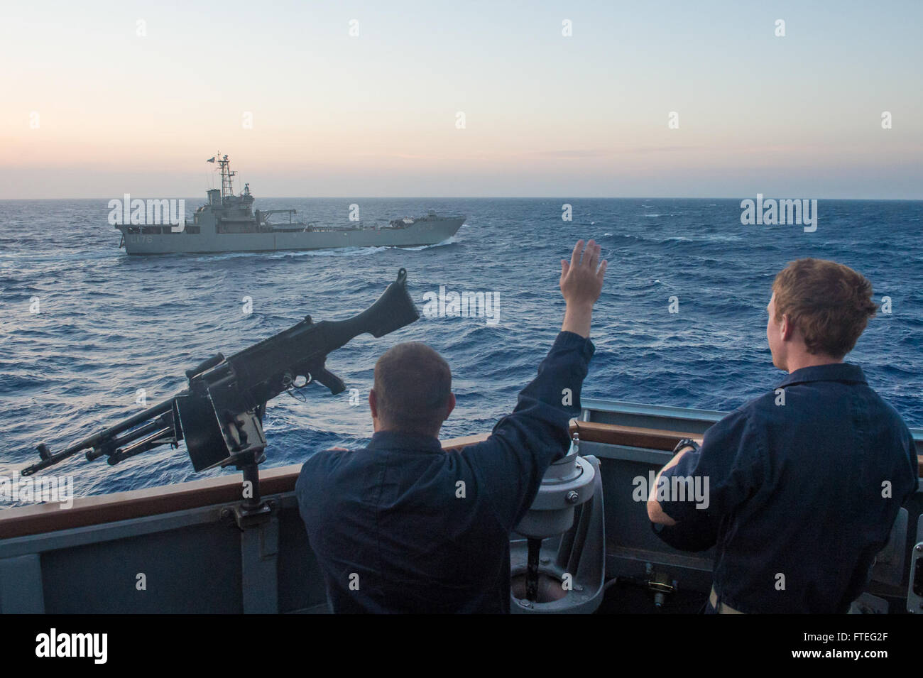 Cmdr. Tadd Gorman, commanding officer of the USS Ross (DDG 71), waves ...
