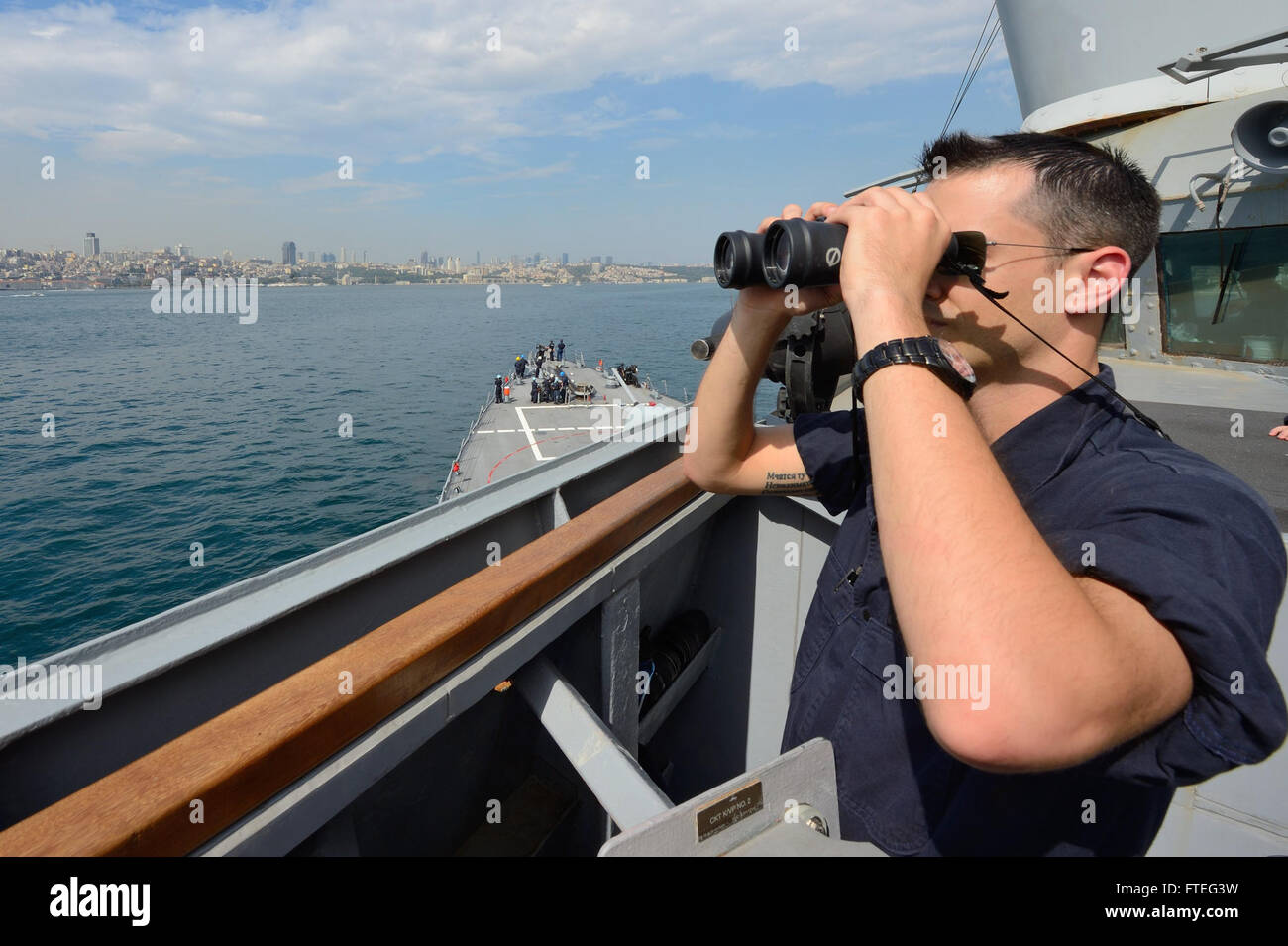 Ensign Shea Miller stands watch aboard the USS Ross (DDG 71), an ...