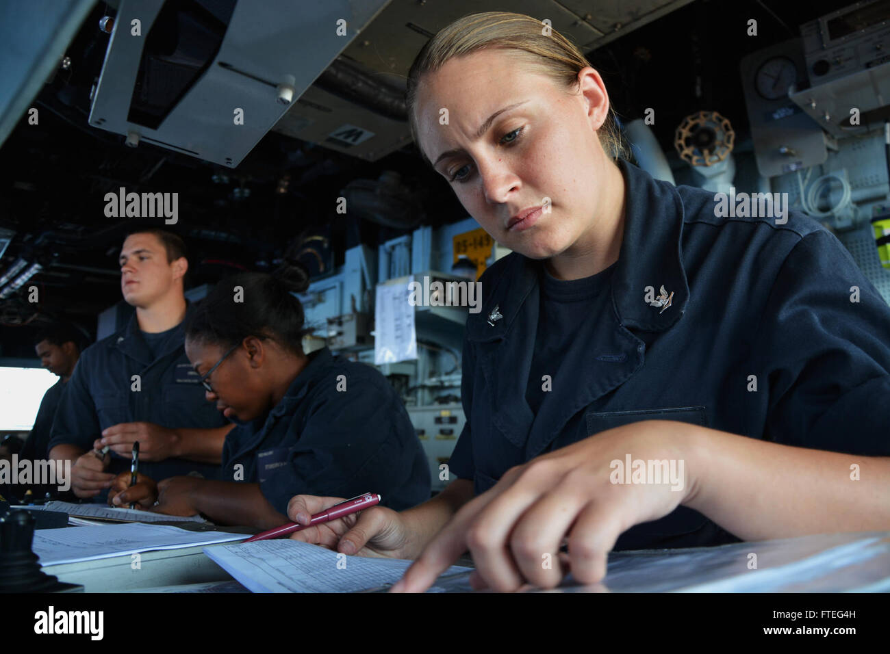 Quartermaster 3rd Class Morgan Hales records weather conditions aboard ...