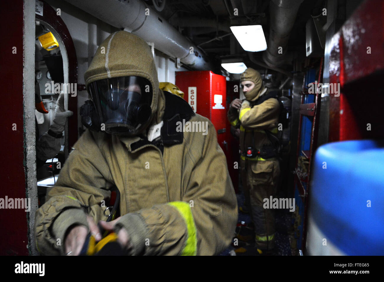 Sailors aboard the USS Vella Gulf participate in firefighting training ...