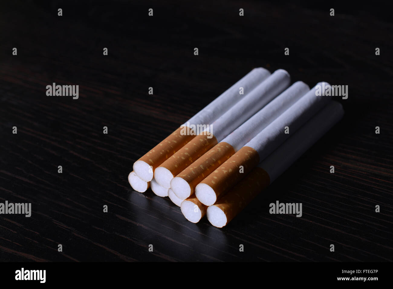 Stack of Cigarettes on black background Stock Photo - Alamy