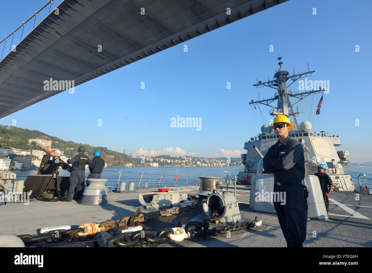 The USS Ross, an Arleigh Burke-class destroyer, is seen passing under a ...