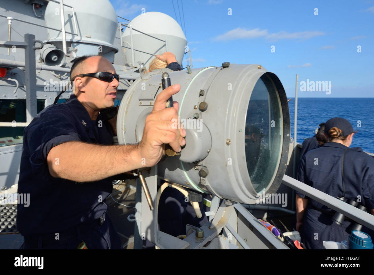 The image captures Quartermaster 1st Class Christopher Allison using a ...