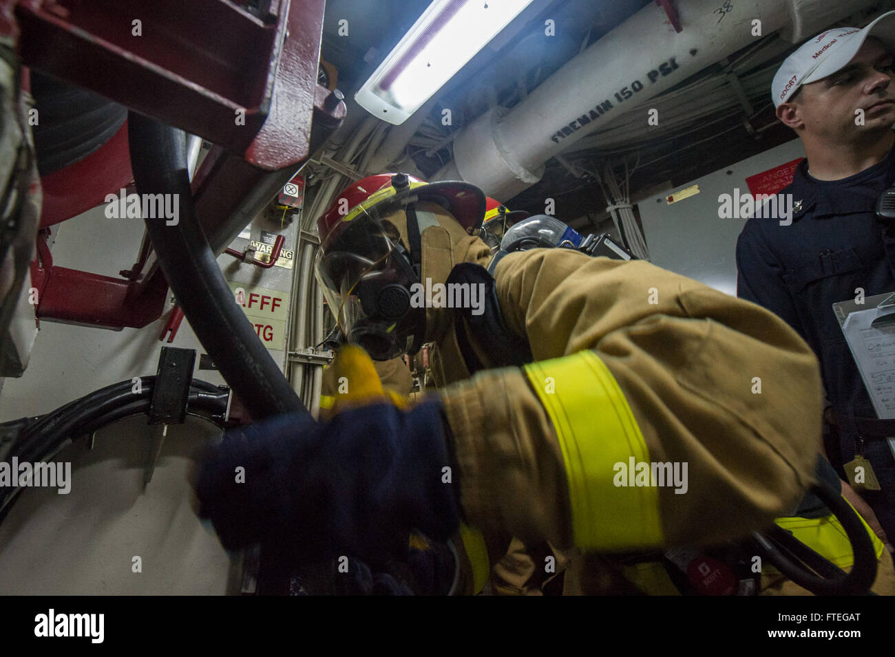 This image captures a naval operations drill aboard the USS Cole (DDG ...