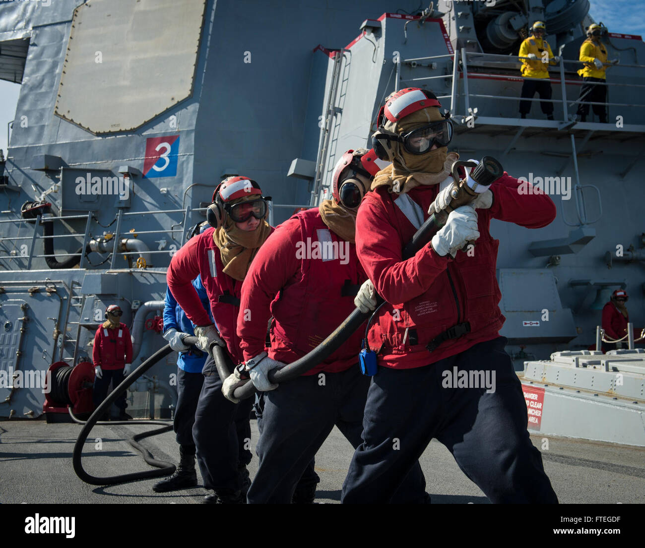 Sailors aboard the USS Mitscher (DDG 57), an Arleigh Burke-class guided ...
