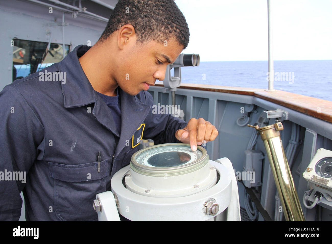 Quartermaster Seaman Apprentice Christopher Barnes examines the ...