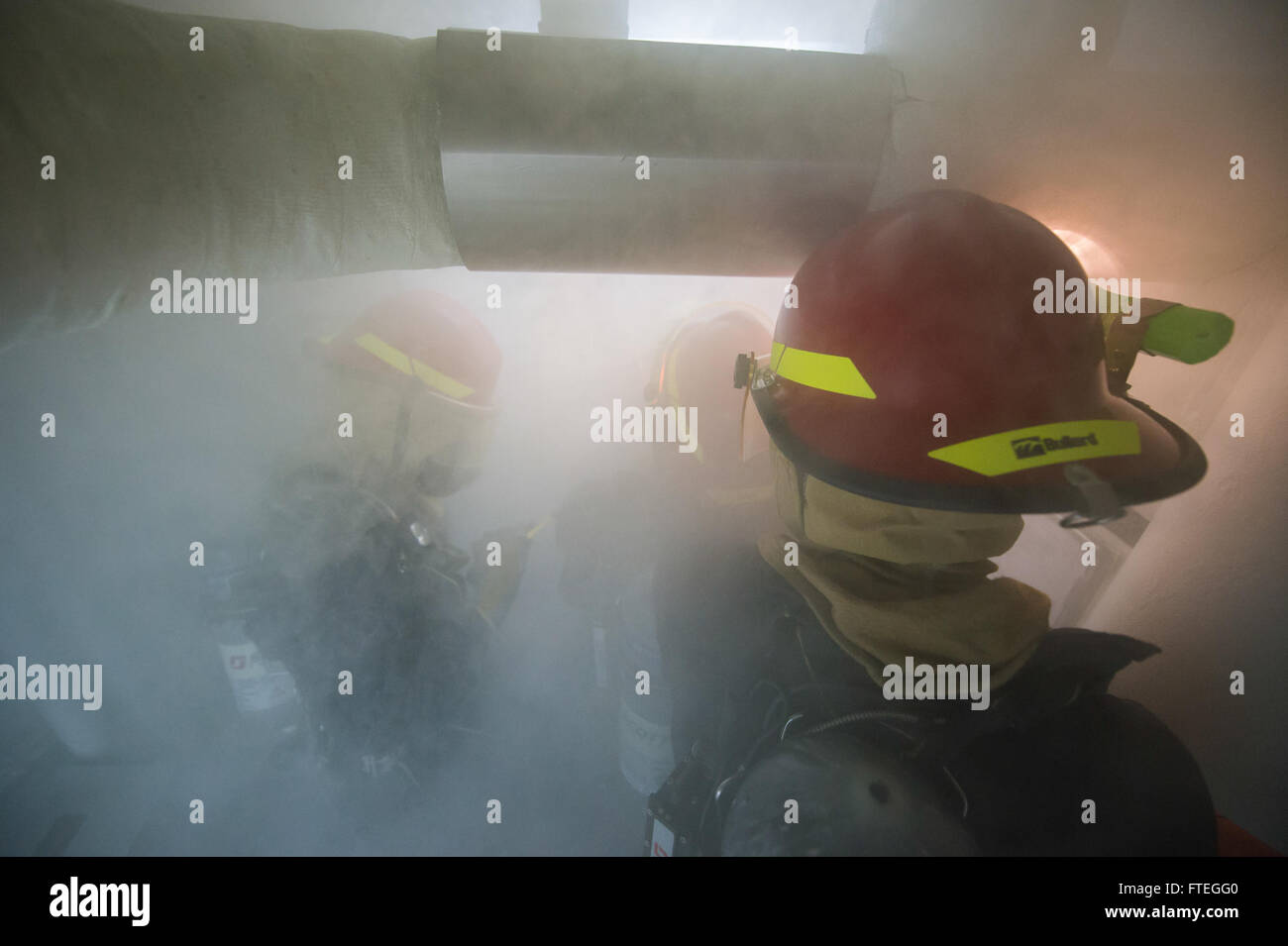 Sailors aboard the USS Cole simulate firefighting during a general ...