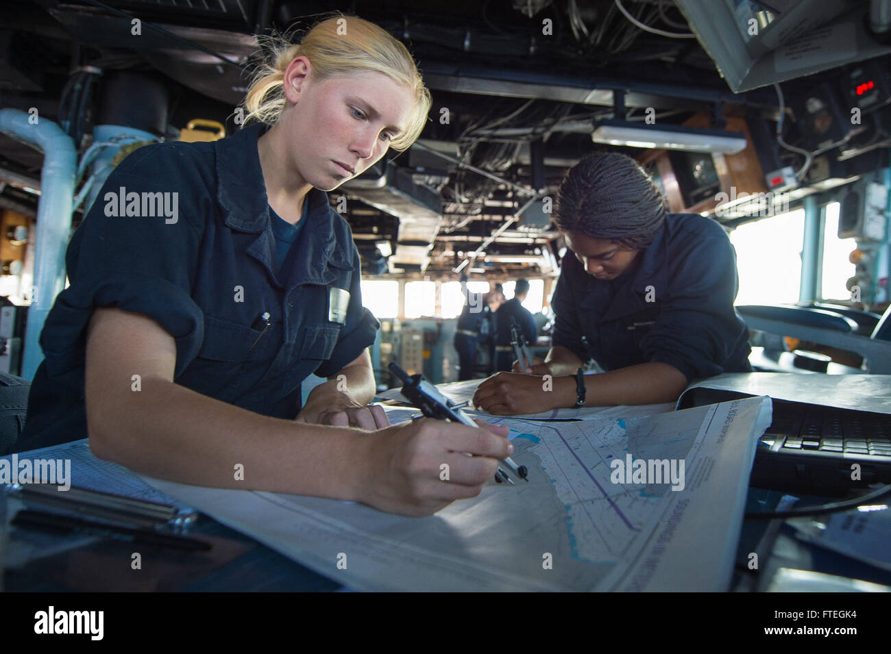Quartermaster Seaman Kelsey Quarterman charts a course on the bridge of ...