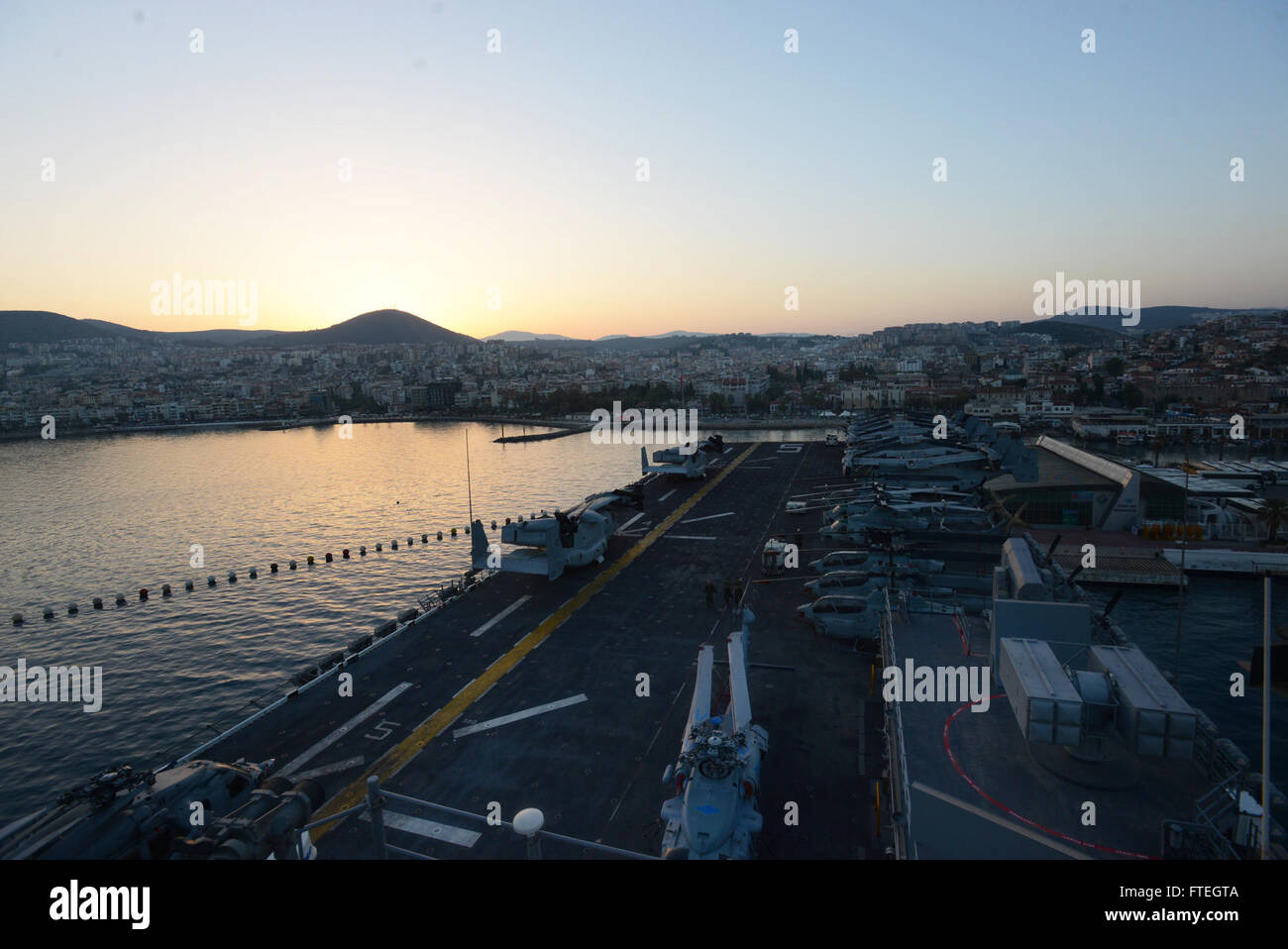The USS Bataan (LHD 5) is shown docked in Kusadasi, Turkey, at sunrise ...