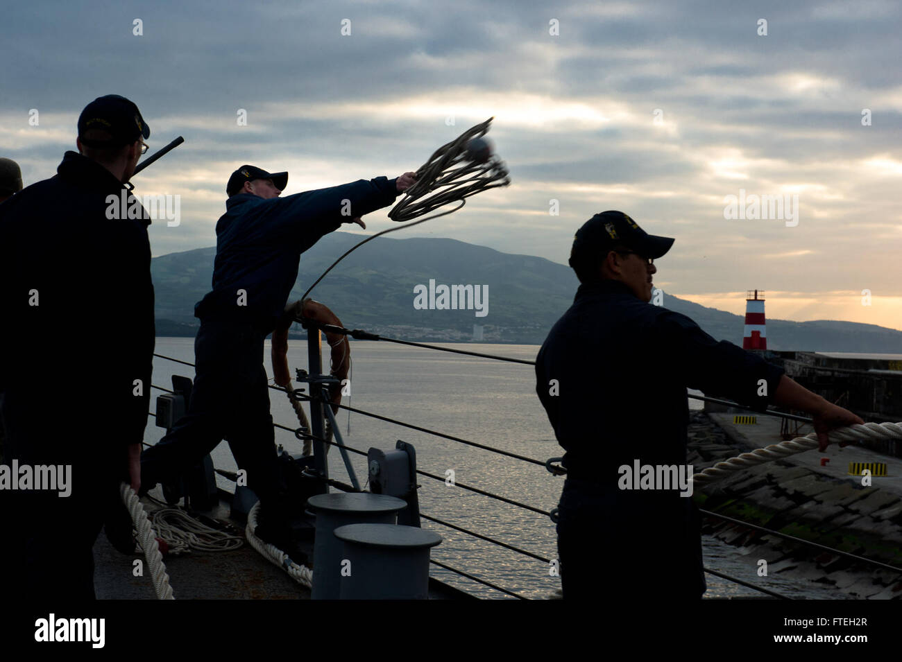 This image shows Boatswain's Mate Seaman Keith Konze throwing a heaving ...