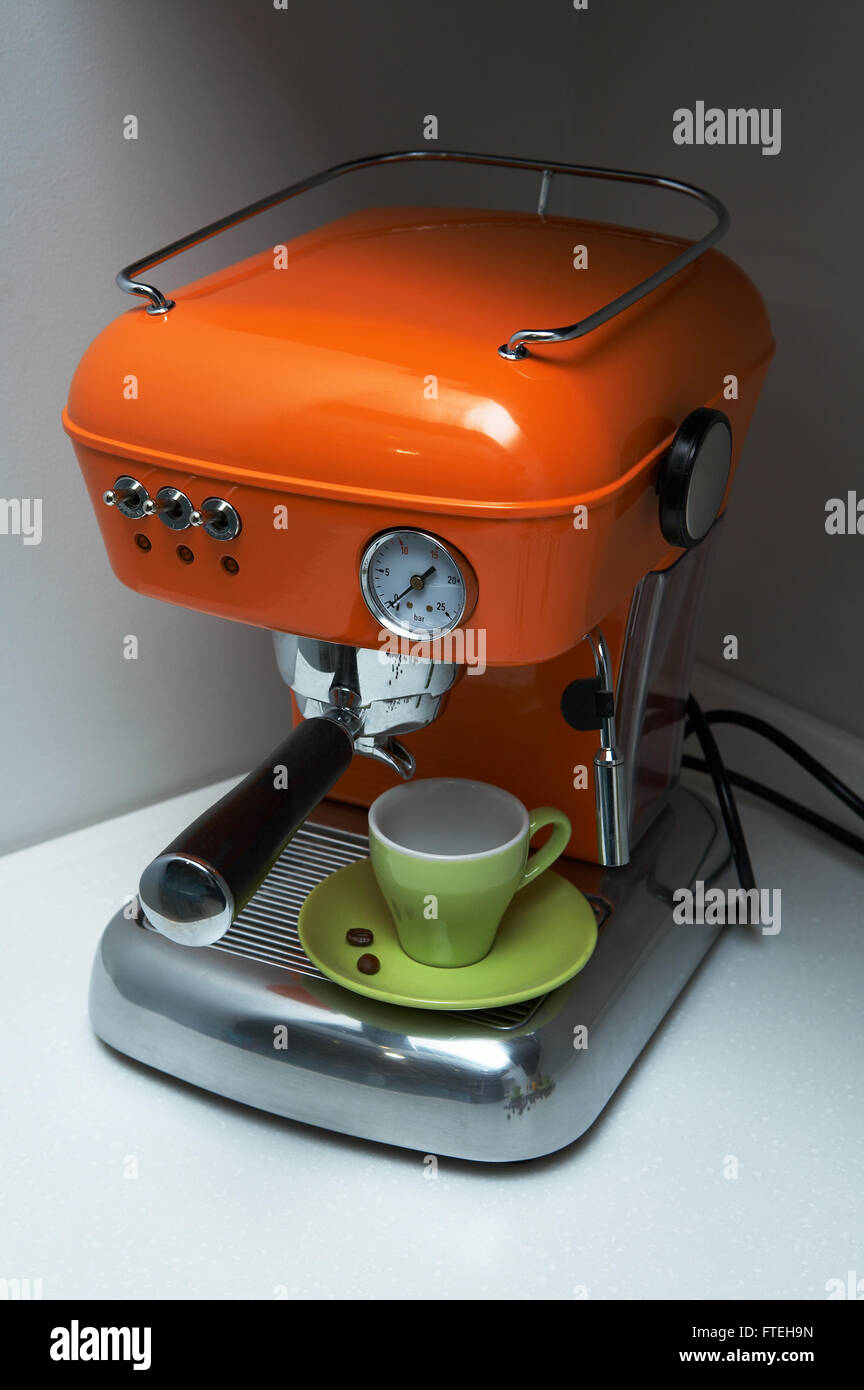Modern and fashionable coffee maker of orange color Stock Photo - Alamy