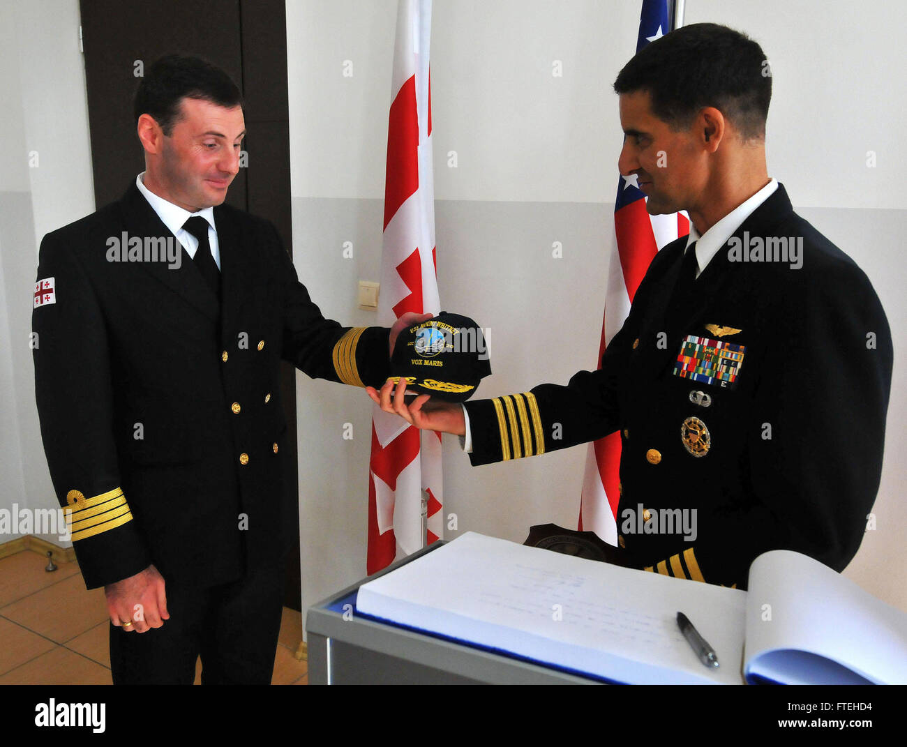 Captain Mark Colombo of the USS Mount Whitney (LCC 20) presents a ...
