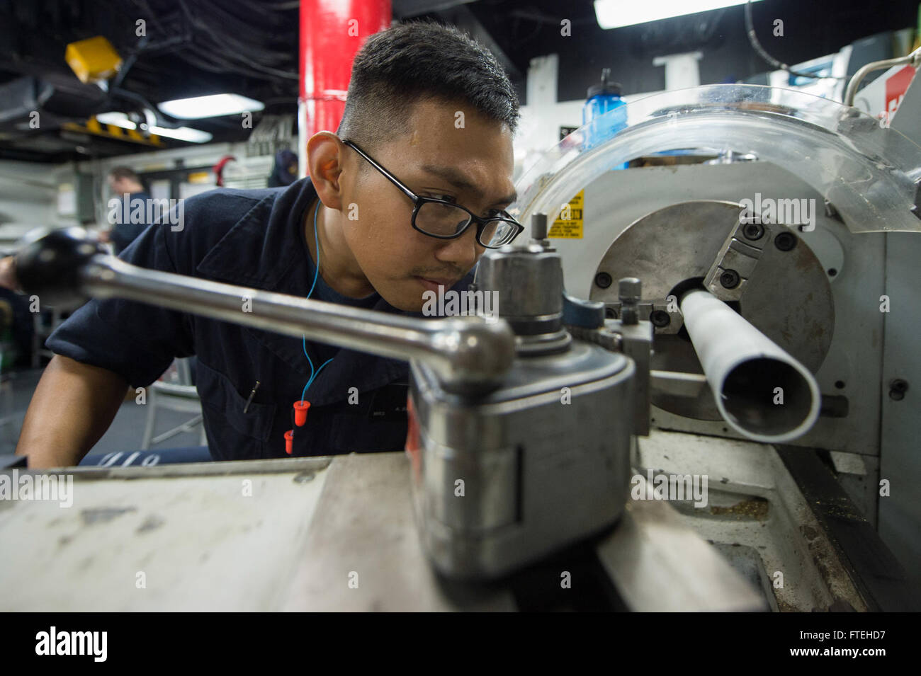 Machinist Repairman 3rd Class Achibald Salcedo adjusts equipment aboard ...