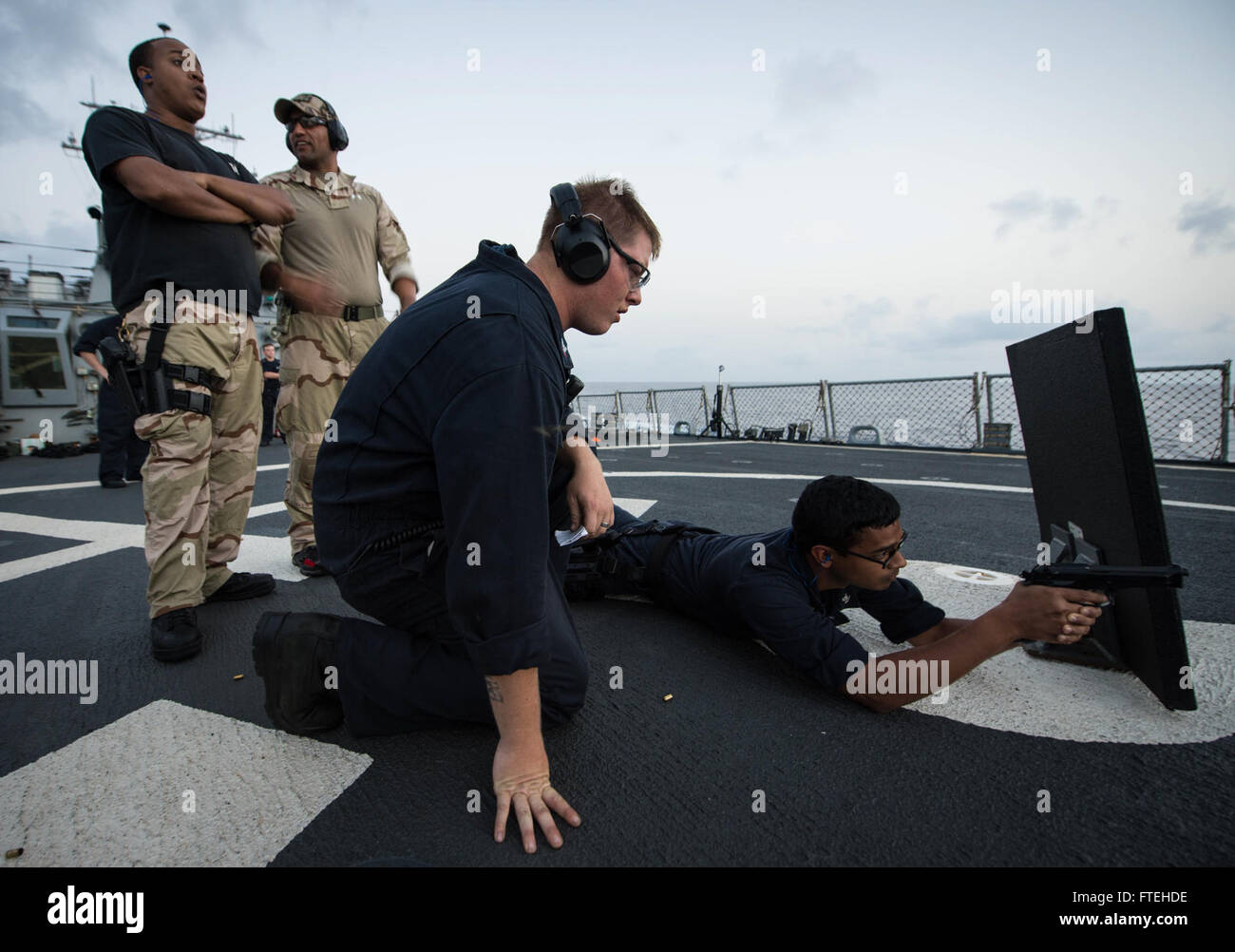 Cryptologic Technician 3rd Class Matthew Hennessey qualifies with a 9mm ...