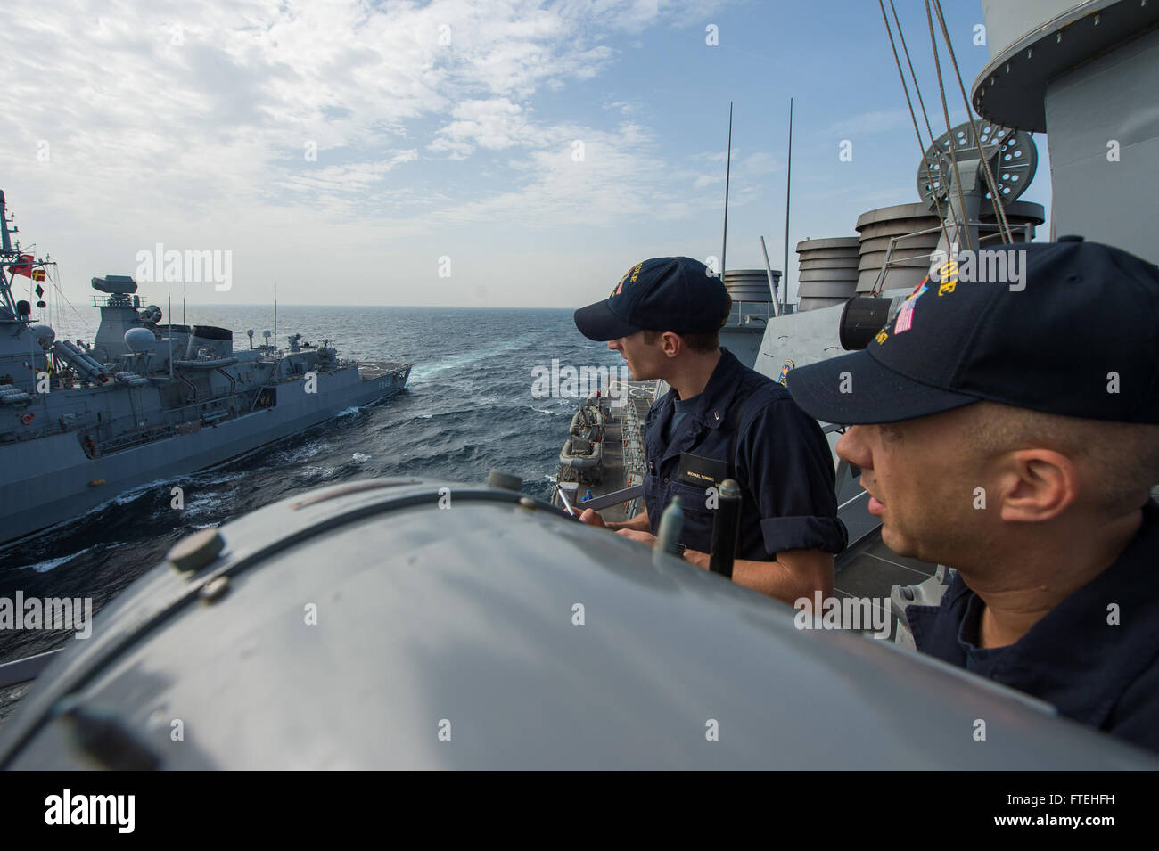 The image depicts Ensign Michael Tomsic and Quartermaster 1st Class ...