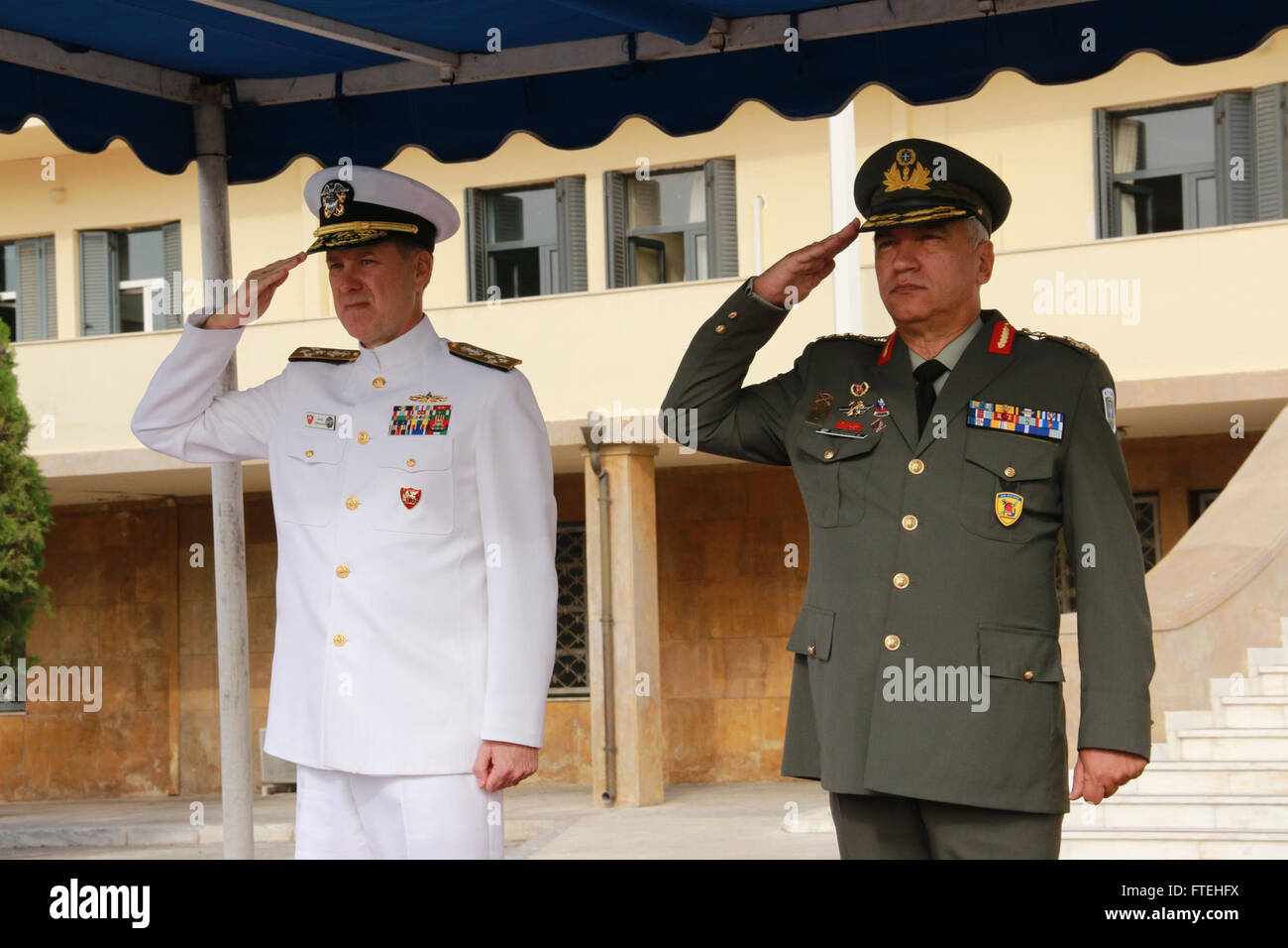 Adm. Mark Ferguson and Gen. Mikhail Kostarakos salute each other during ...