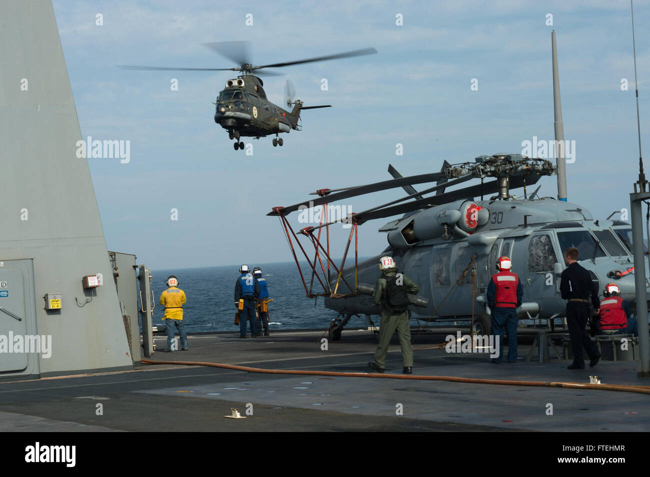 A Romanian Navy IAR-330 helicopter performs flight operations aboard ...