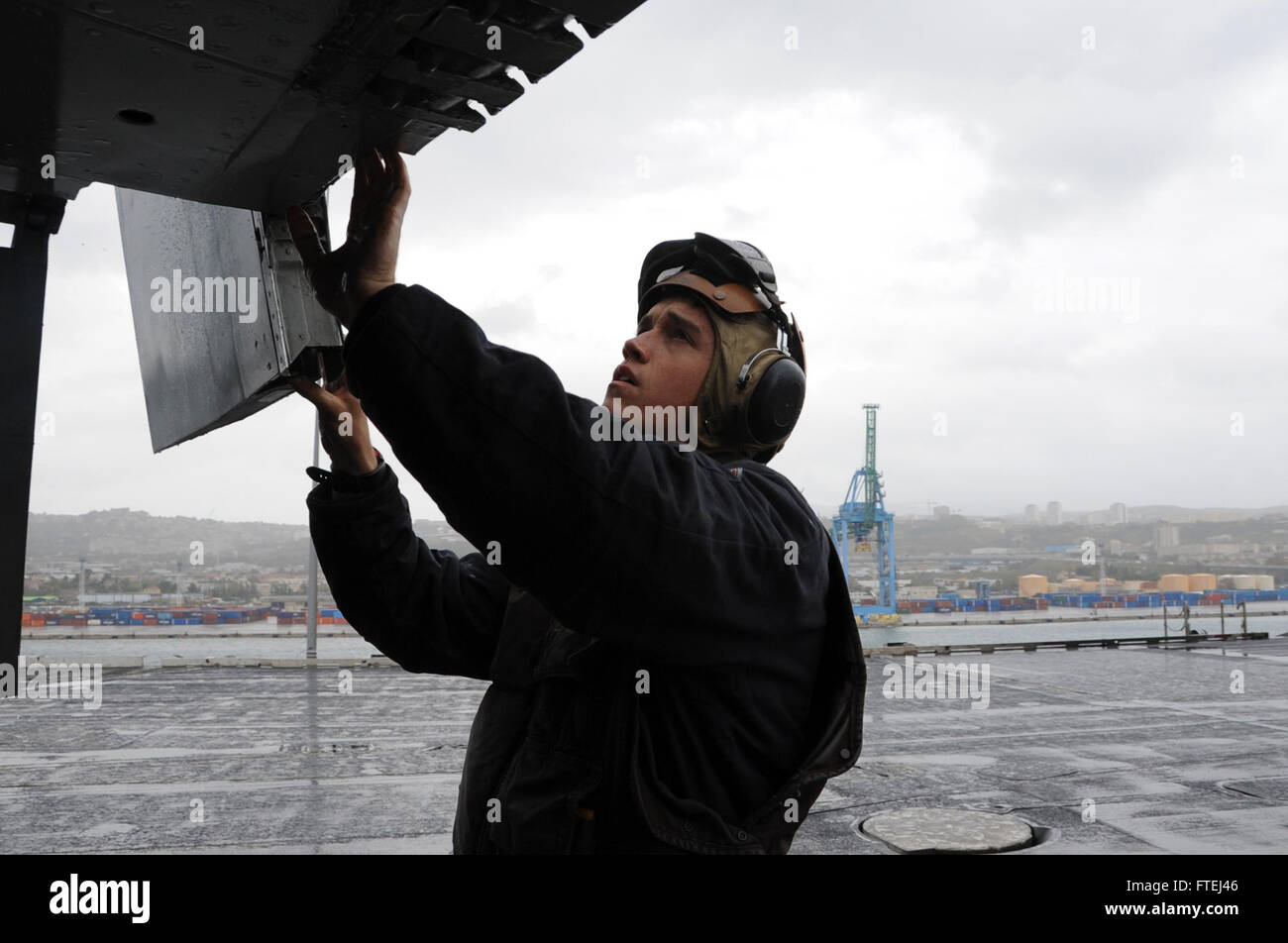Airman Daniel Evans conducts a daily inspection on an F/A-18C Hornet ...