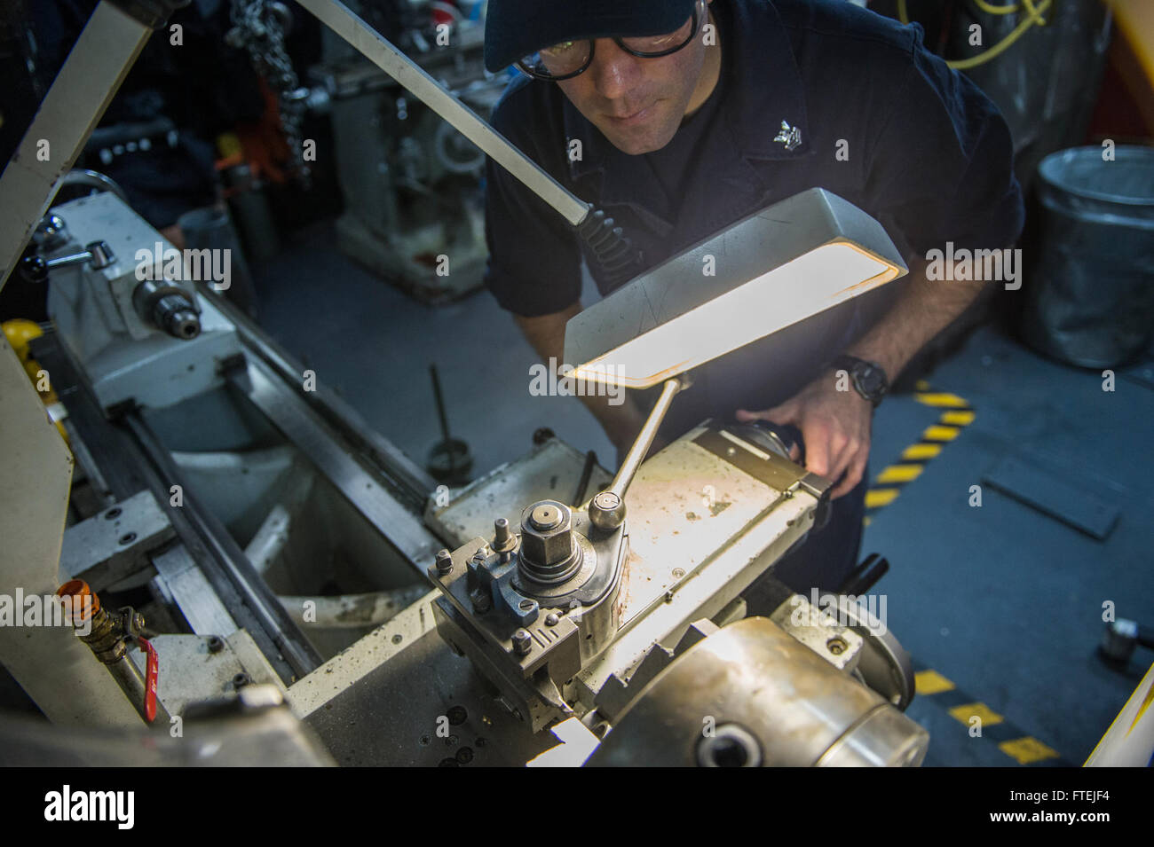 Machinery Repairman 1st Class Phillip Marcotte works aboard the USS ...