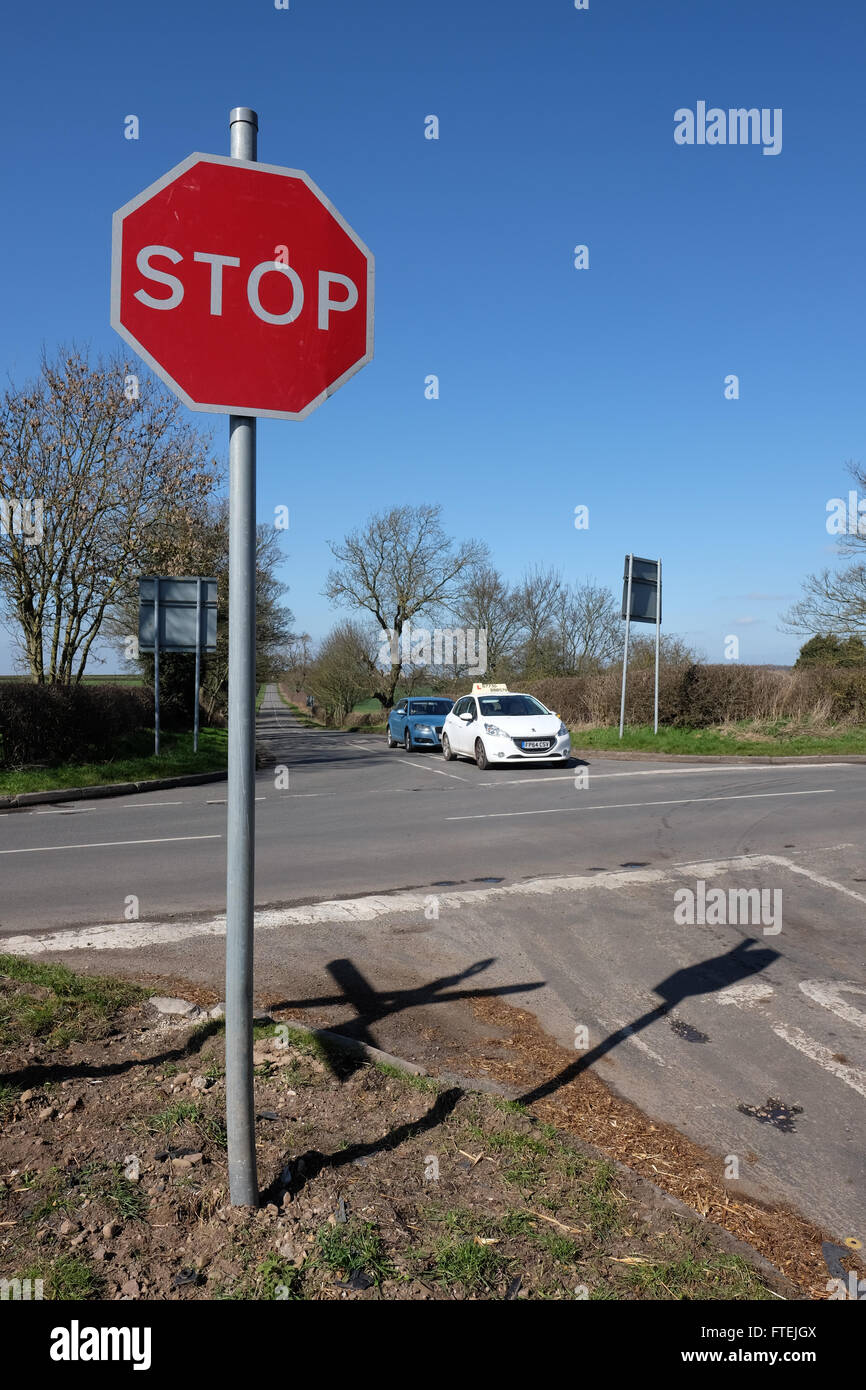 stop sign with cars in the background Stock Photo - Alamy