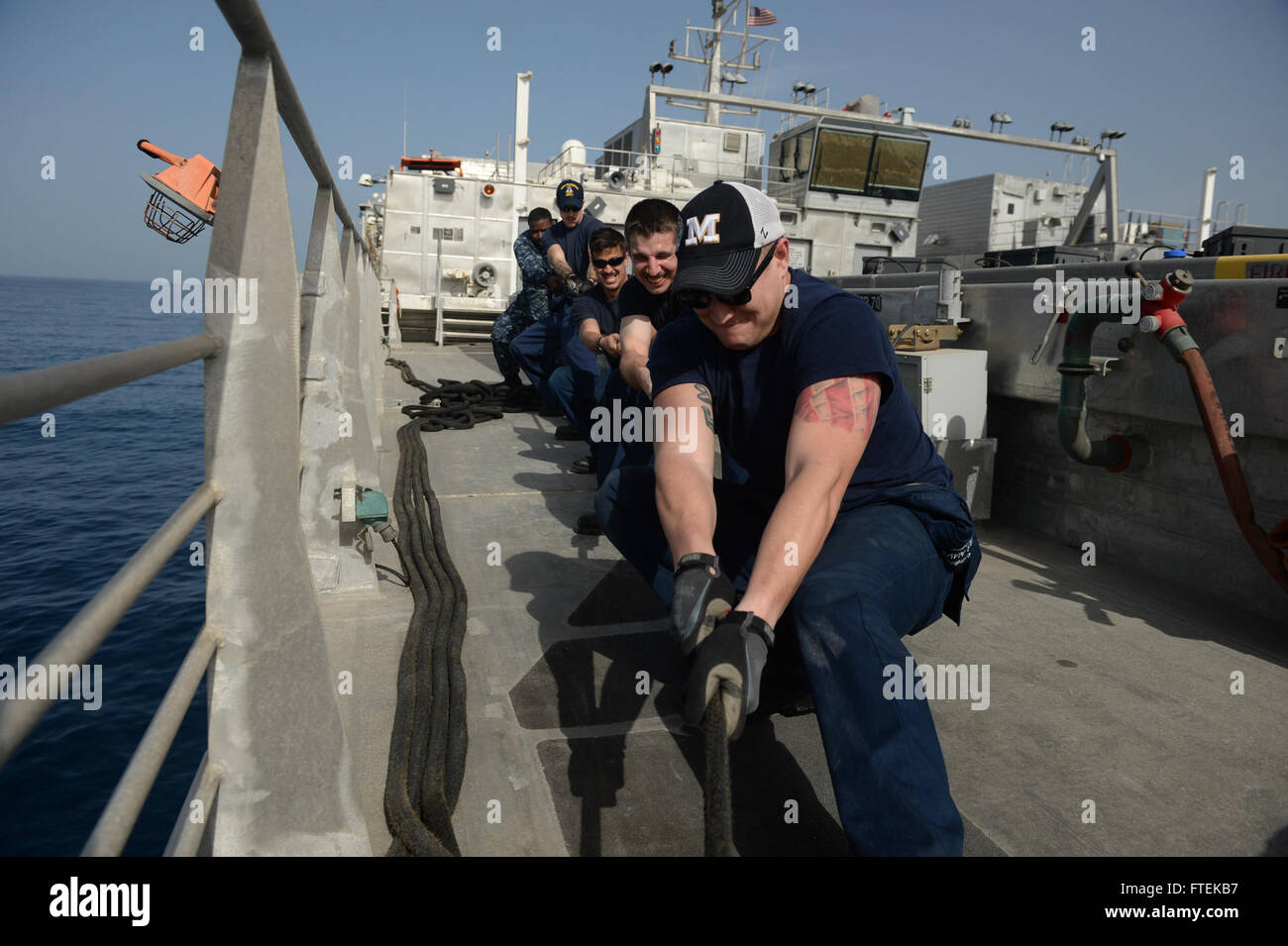 Sailors aboard the USNS Spearhead assist with small boat operations on the flight deck as part ...