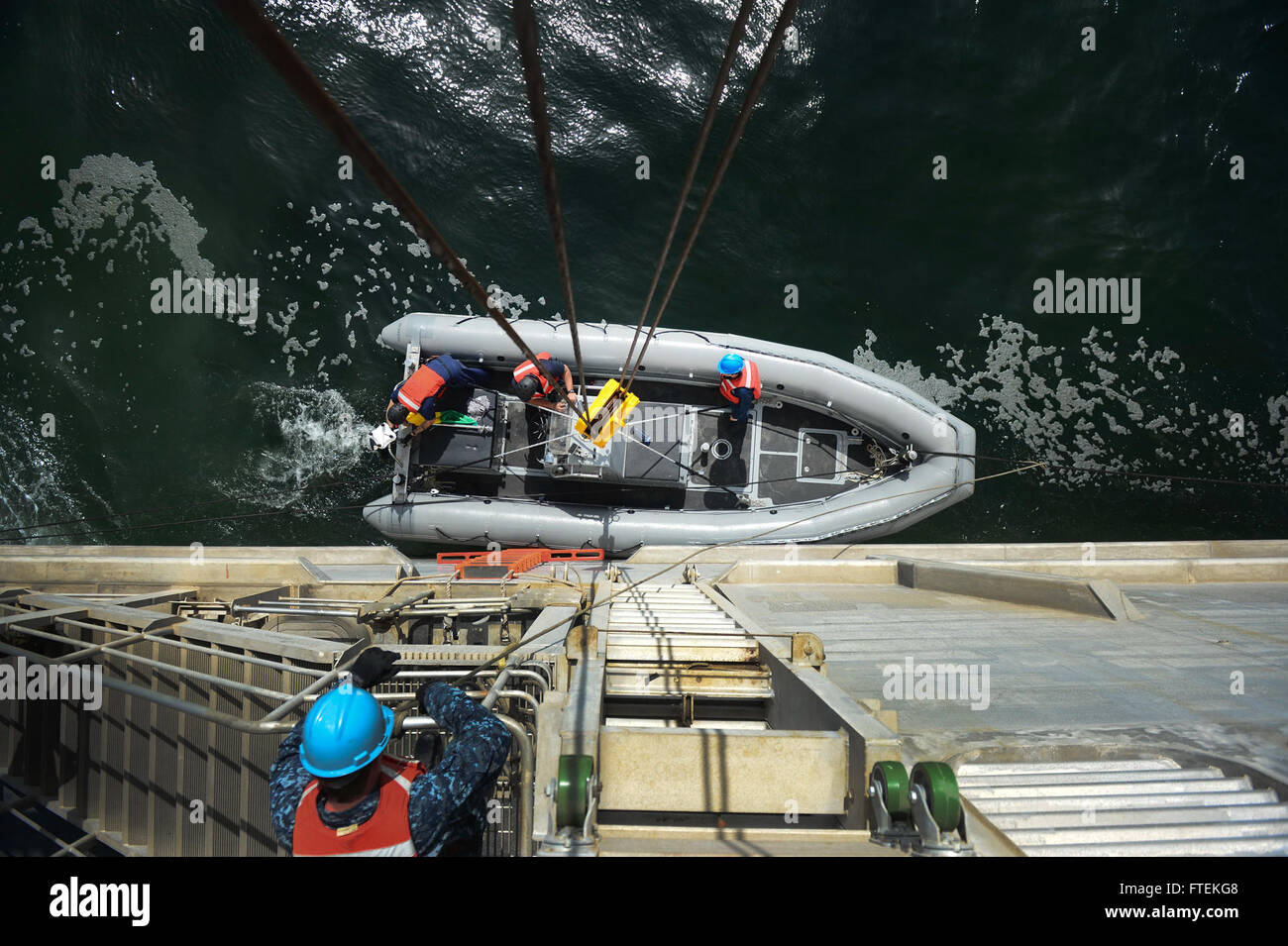 This image shows U.S. Navy and Coast Guardsmen conducting small-boat ...