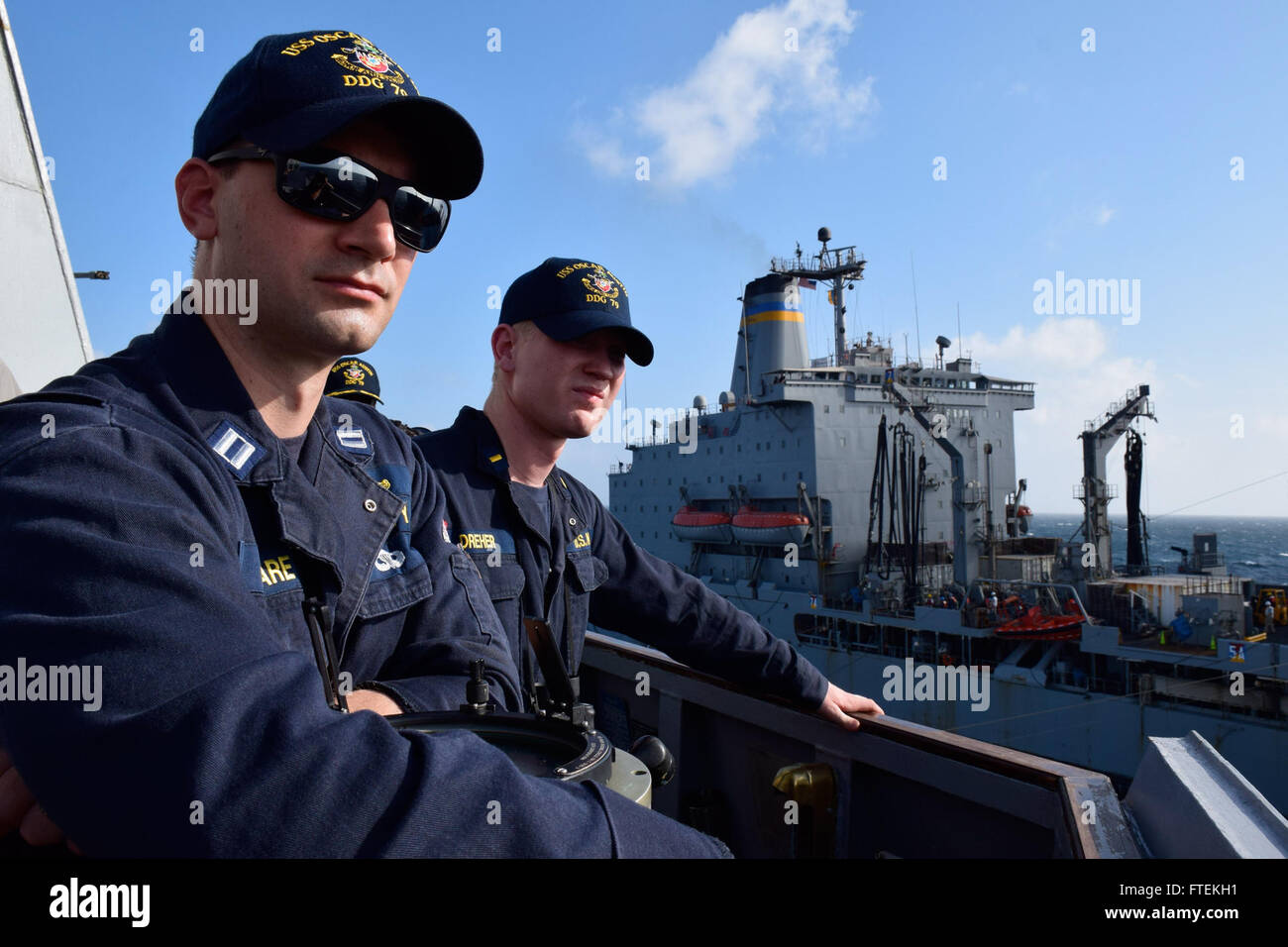 This image shows Lt. Jason Copare coaching Ensign Gregory Dreher during ...