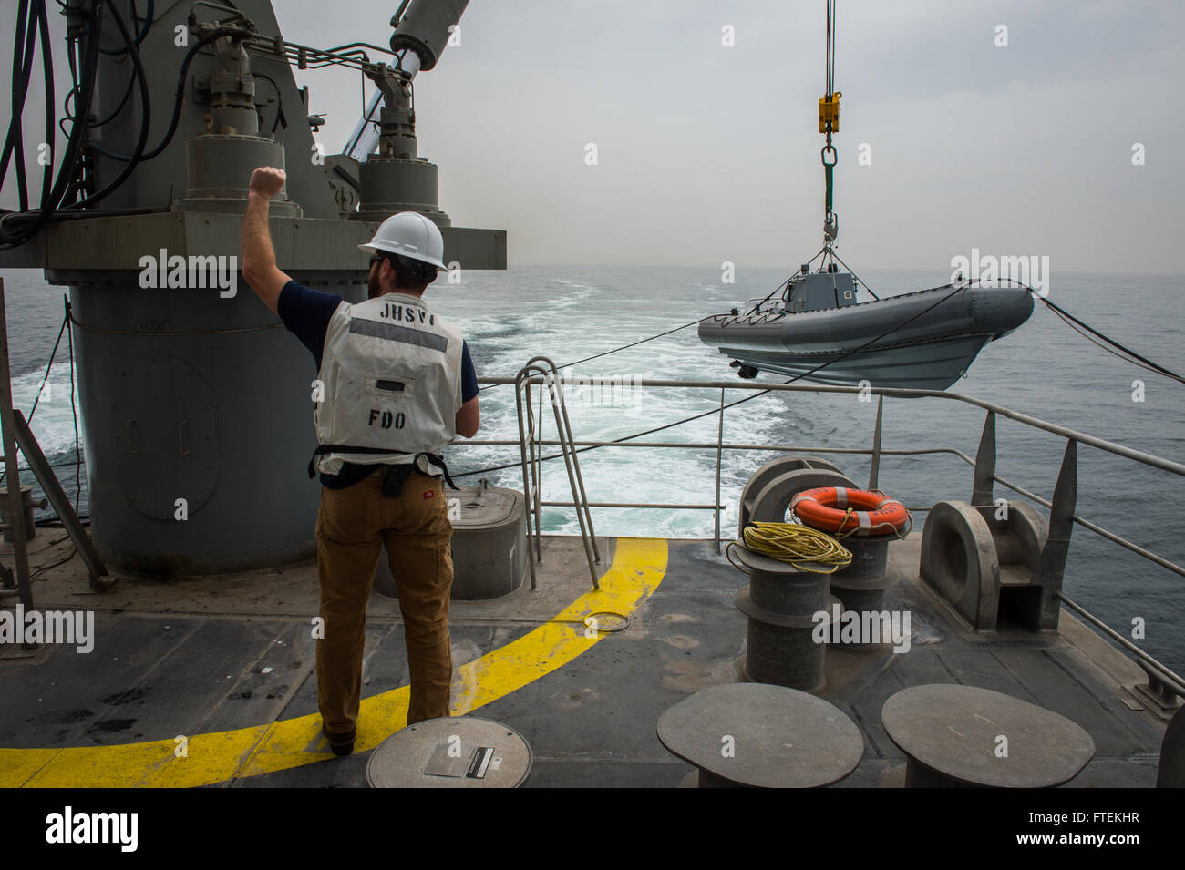 A U.S. Navy photo showing Chief Mate James Regan overseeing line ...