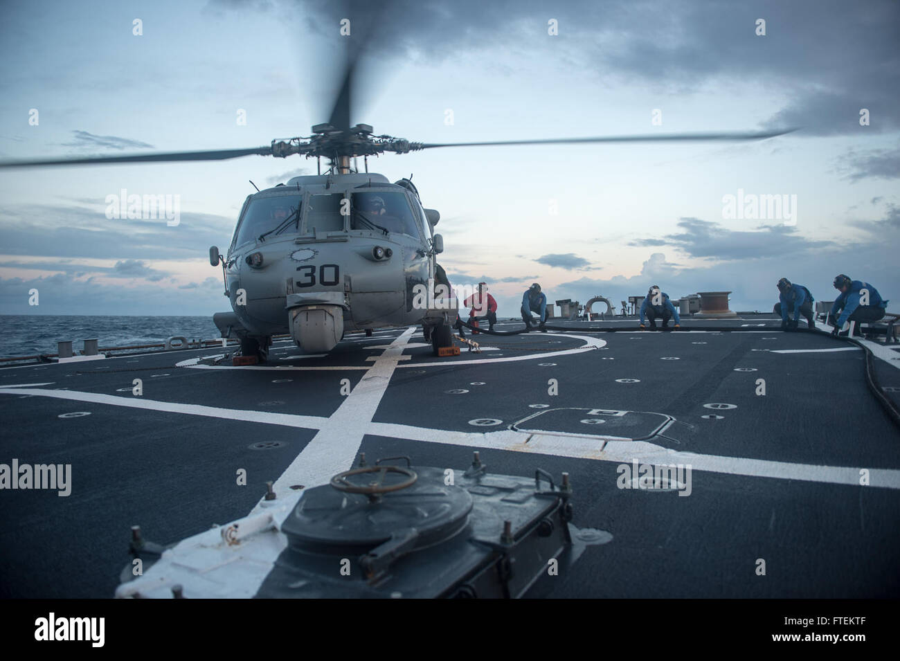 The photo shows sailors aboard the USS Donald Cook (DDG 75) conducting ...
