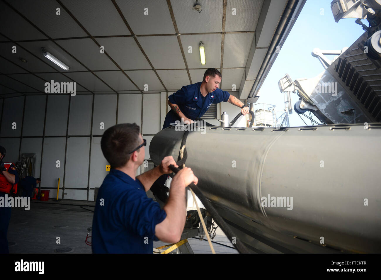 Engineman 2nd Class Chris Carpenter prepares for small boat operations ...