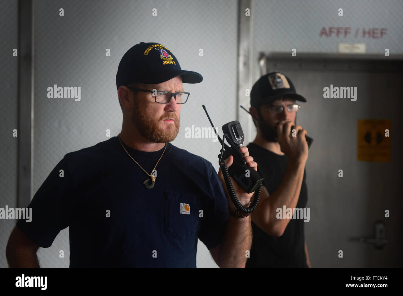Second Officer Ray Barnett listens to communications during a fire ...