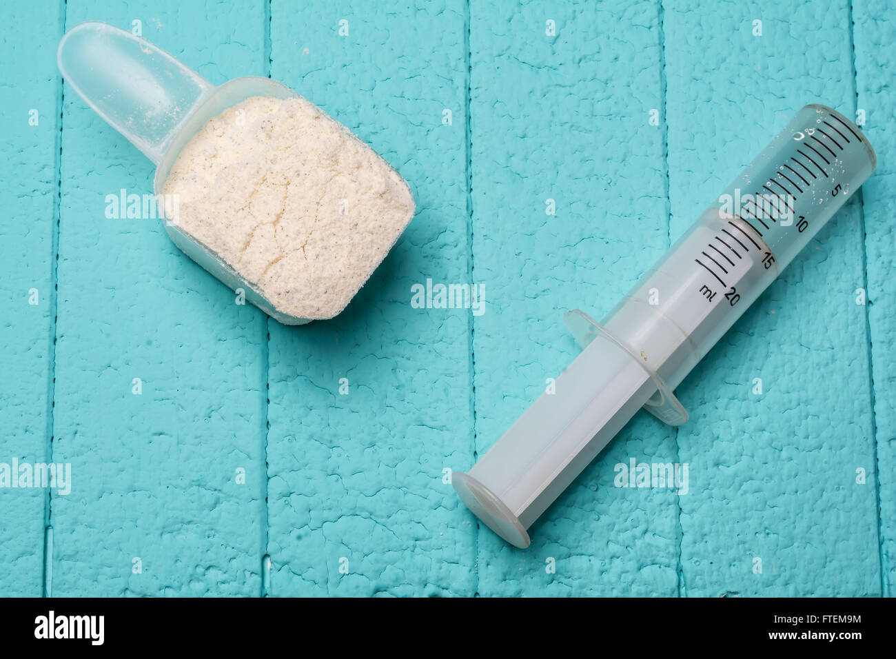Container of milk whey protein and empty injection. Close-up. Blue ...