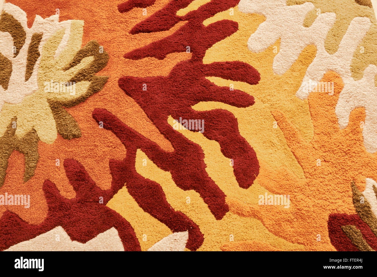 Carpet with colourful patterns in red, yellow, beige and brown Stock ...