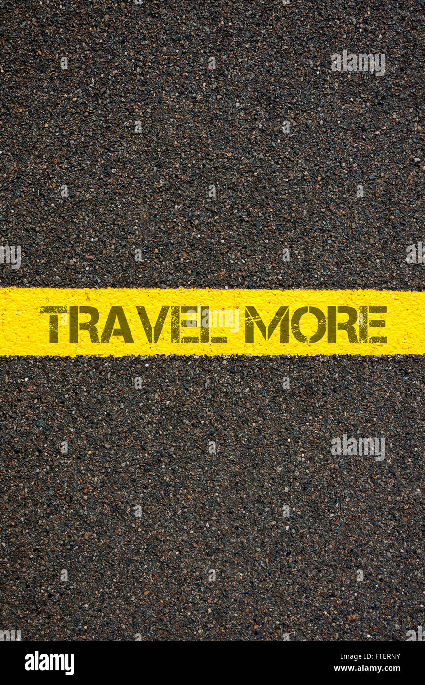 Road marking yellow paint dividing line with words TRAVEL MORE, concept ...