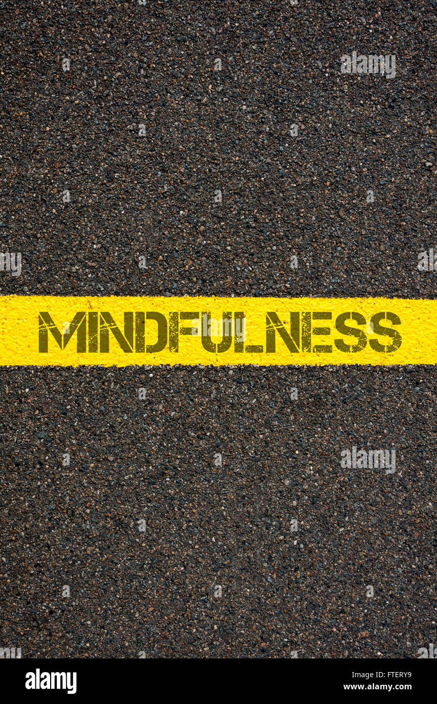 Road marking yellow paint dividing line with word MINDFULNESS, concept ...