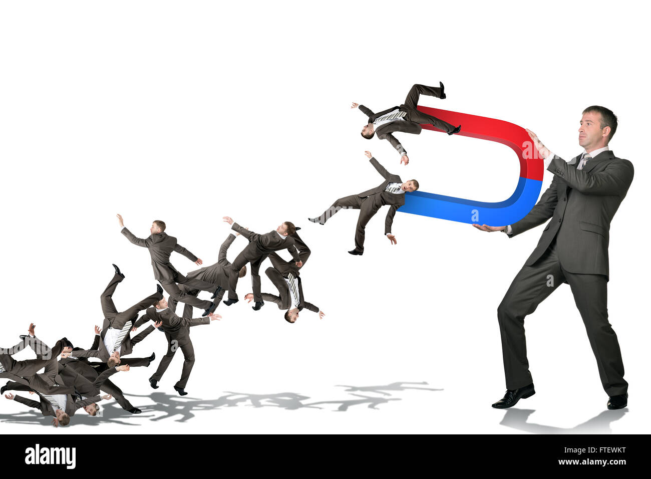 Businessman catching people on magnet Stock Photo - Alamy