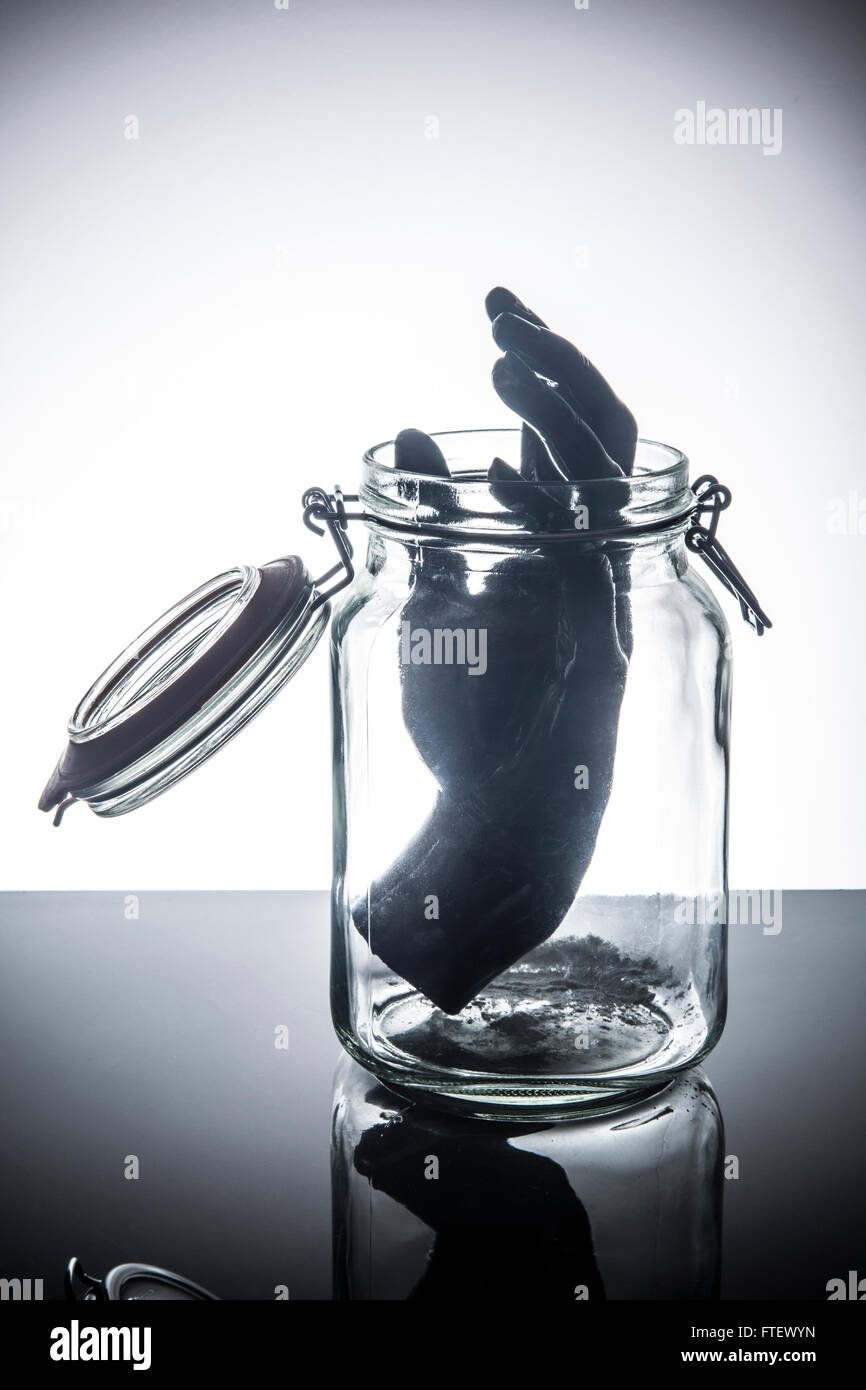 Hand inside a jar Stock Photo - Alamy