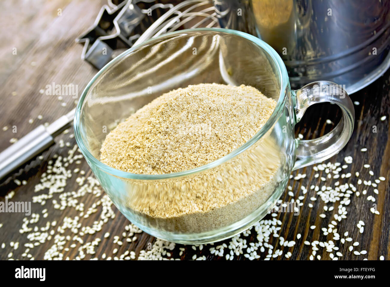 Flour sesame in cup with sieve on board Stock Photo - Alamy