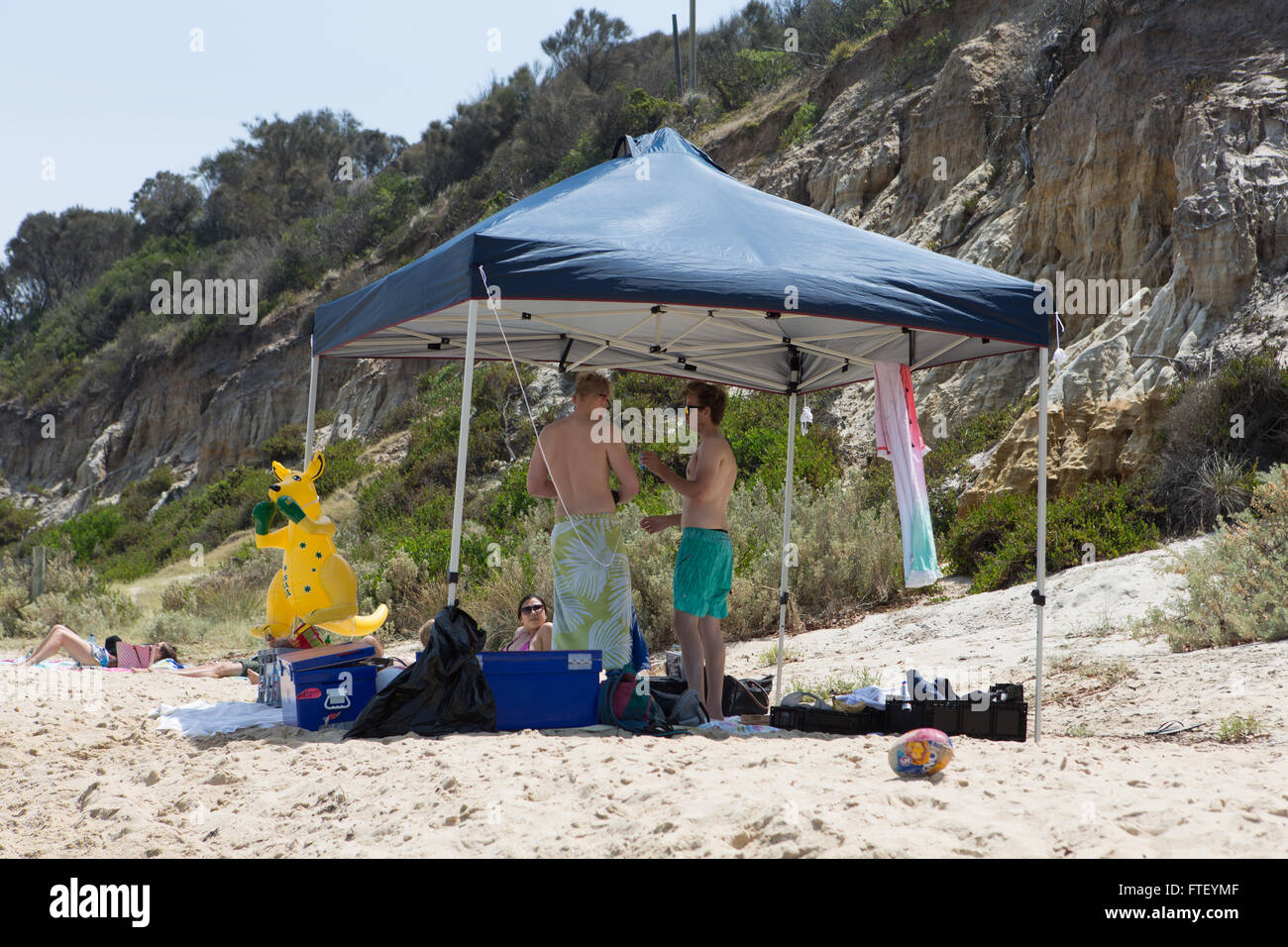 People enjoying the sunshine on the beach at Black Rock, Victoria ...