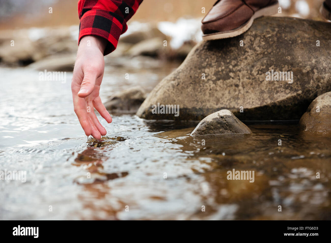Closeup portrait of a male hand testing water in river Stock Photo - Alamy