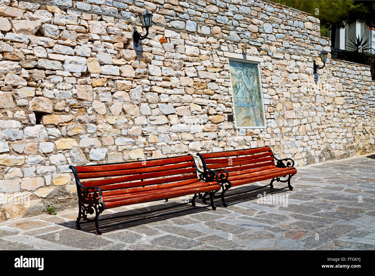 chair and stone pavement in the greece island of paros old bench near a ...