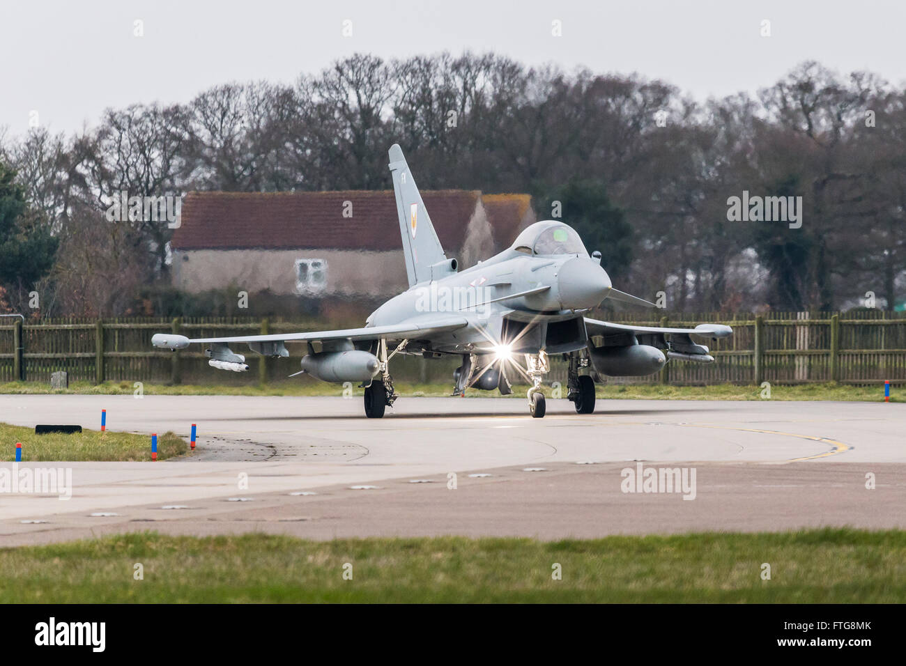 Starburst from a light under an RAF Typhoon taxiing onto the runway at ...