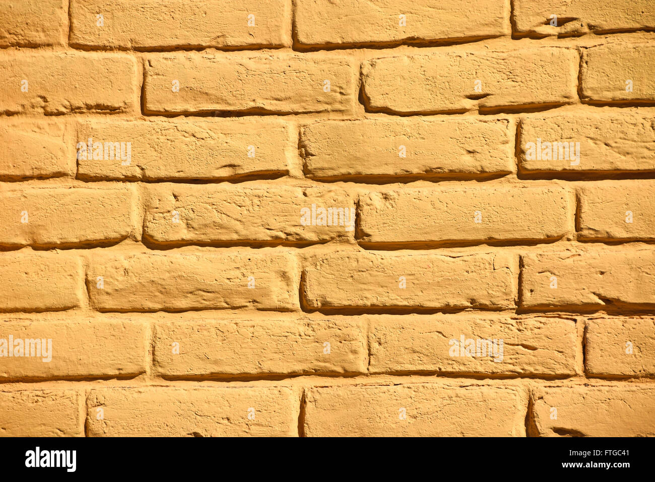 Yellow brick wall pattern Stock Photo - Alamy
