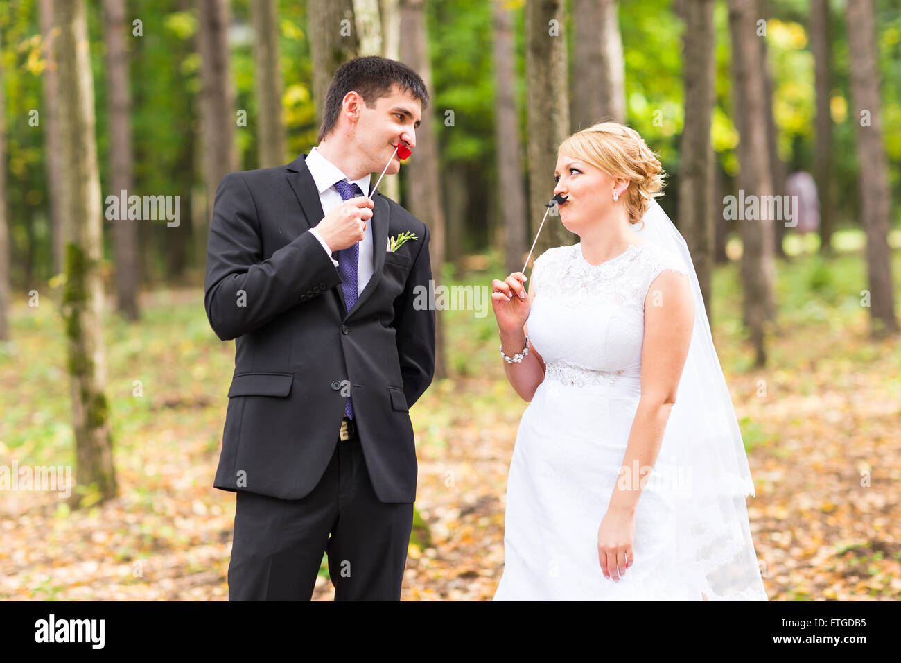 April Fools' Day. Wedding couple posing with stick lips, mask Stock ...