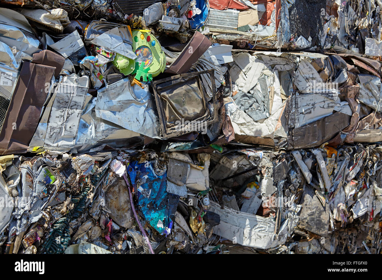 Metal scrap garbage compacted for recycling Stock Photo - Alamy