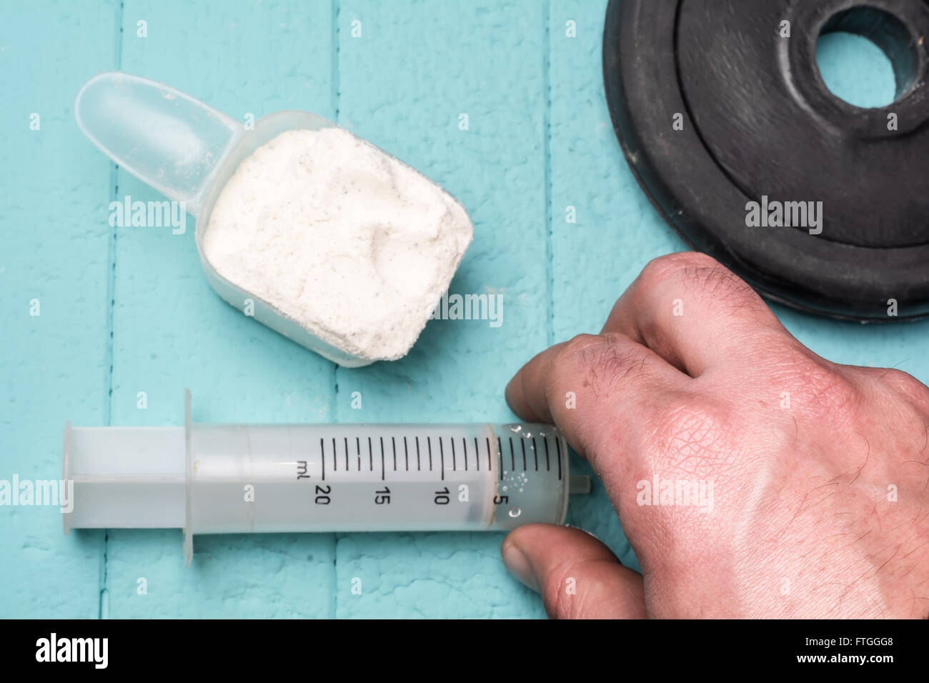 Container of milk whey protein, injection and disc from dumbbell. Close ...