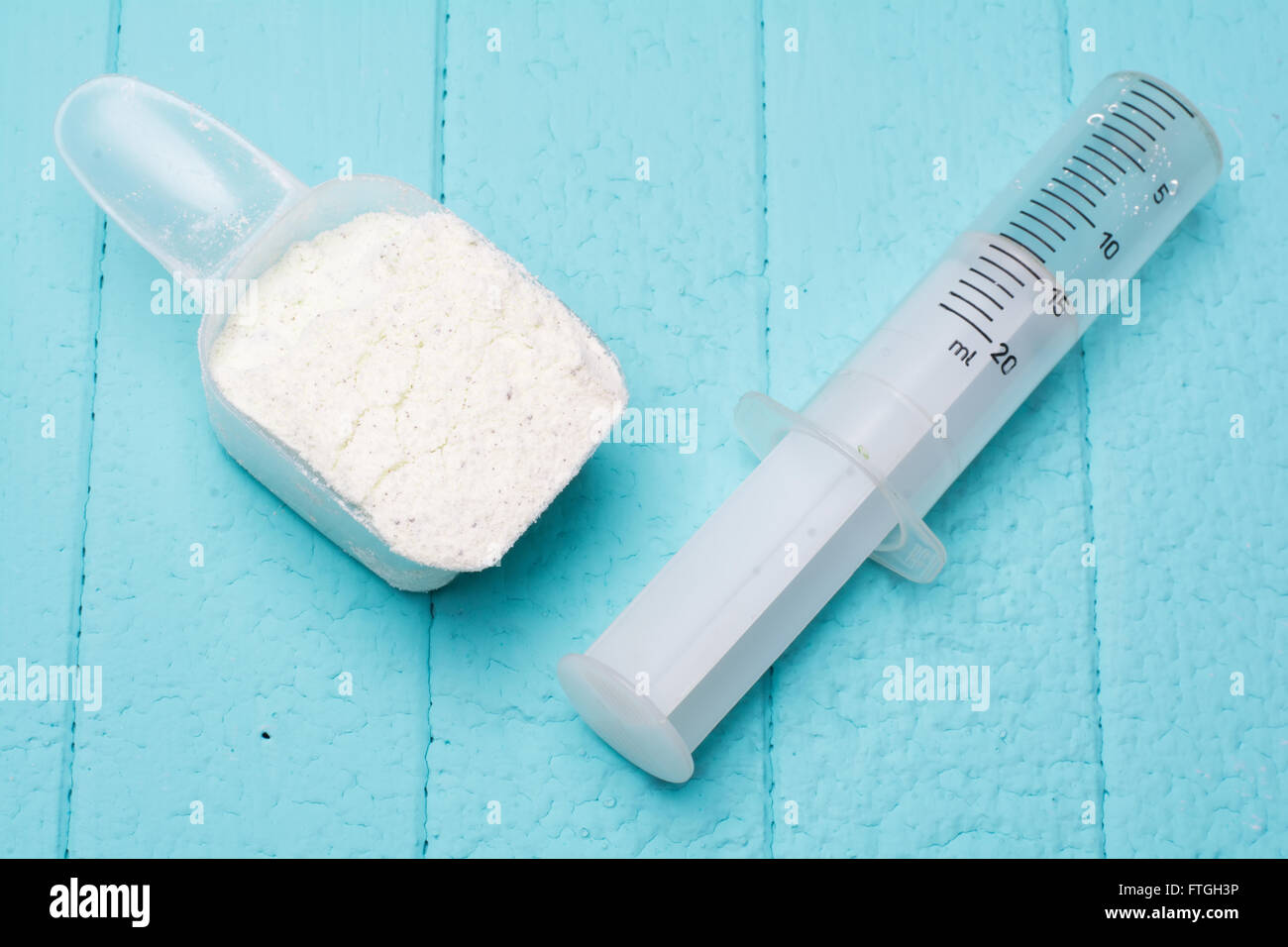 Container of milk whey protein and empty injection. Close-up. Blue ...