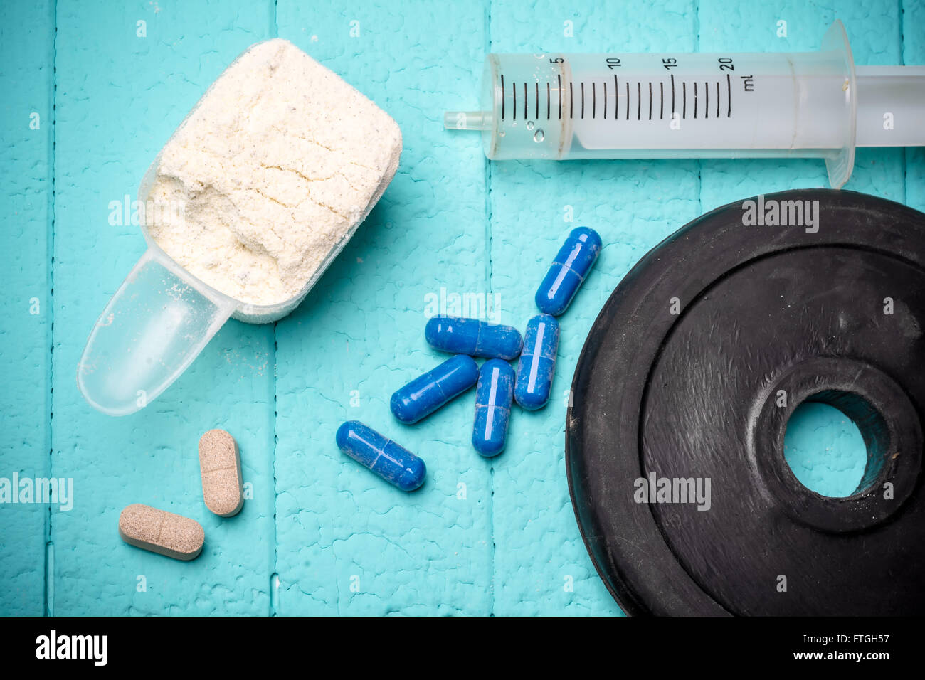 Container of milk whey protein, injection and disc from dumbbell. Close ...