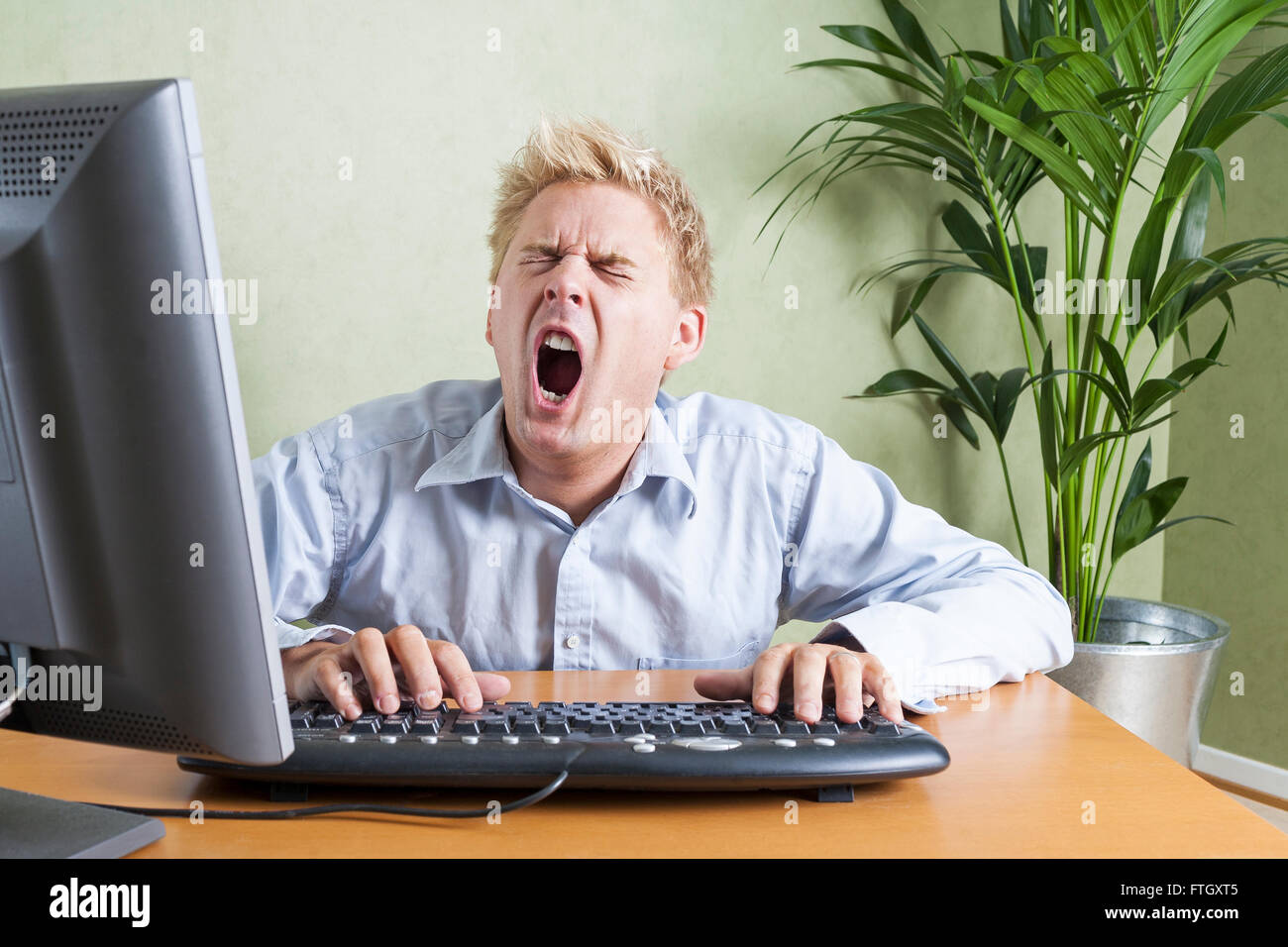 Tired Man Yawning When Working In Front Of Computer In Office Model Release Yes Property